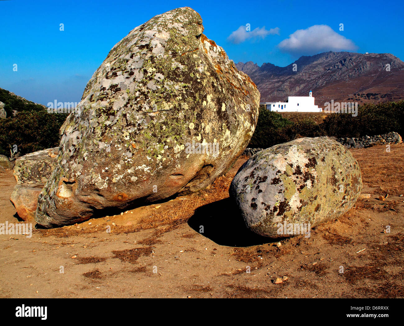 Greece, Cyclades, Tinos island, Large rocks, church in background Stock ...