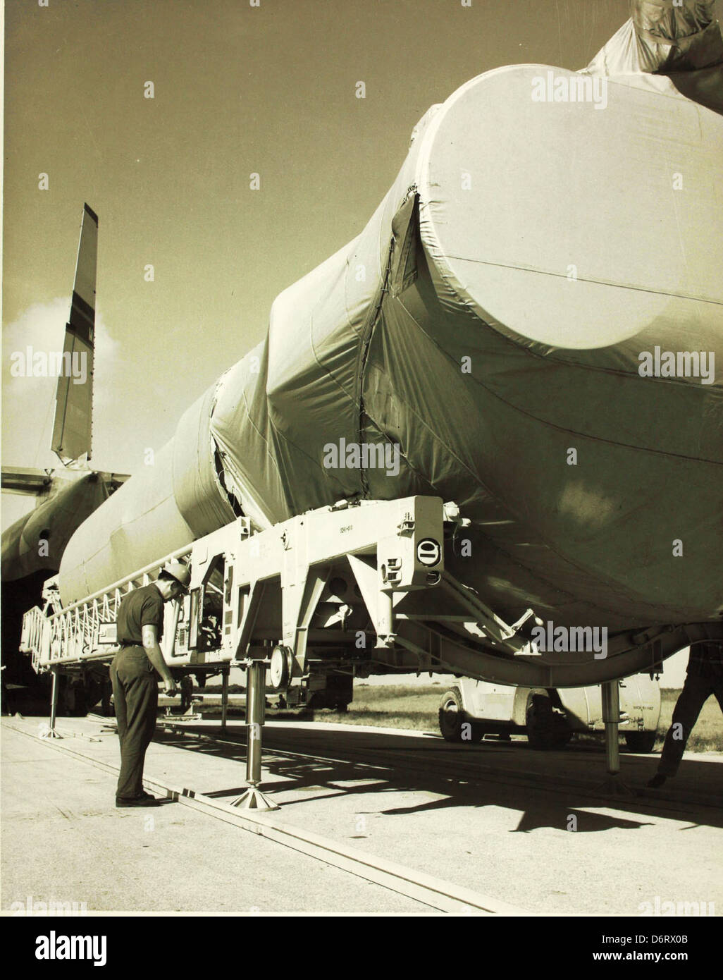 This photograph captures the unloading of the Atlas 3E rocket at ...