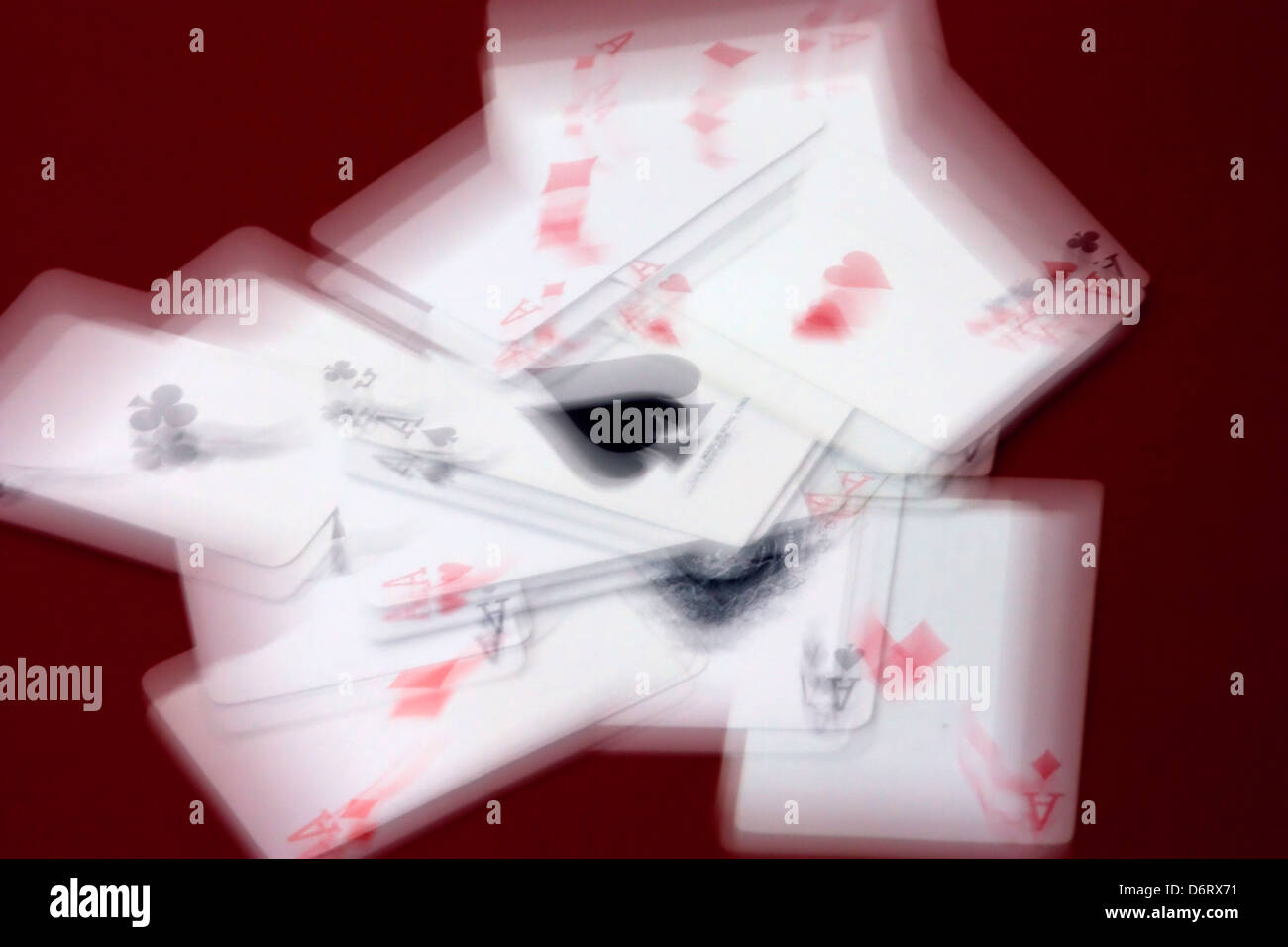 Playing cards appear to explode around the ace of spades Stock Photo ...