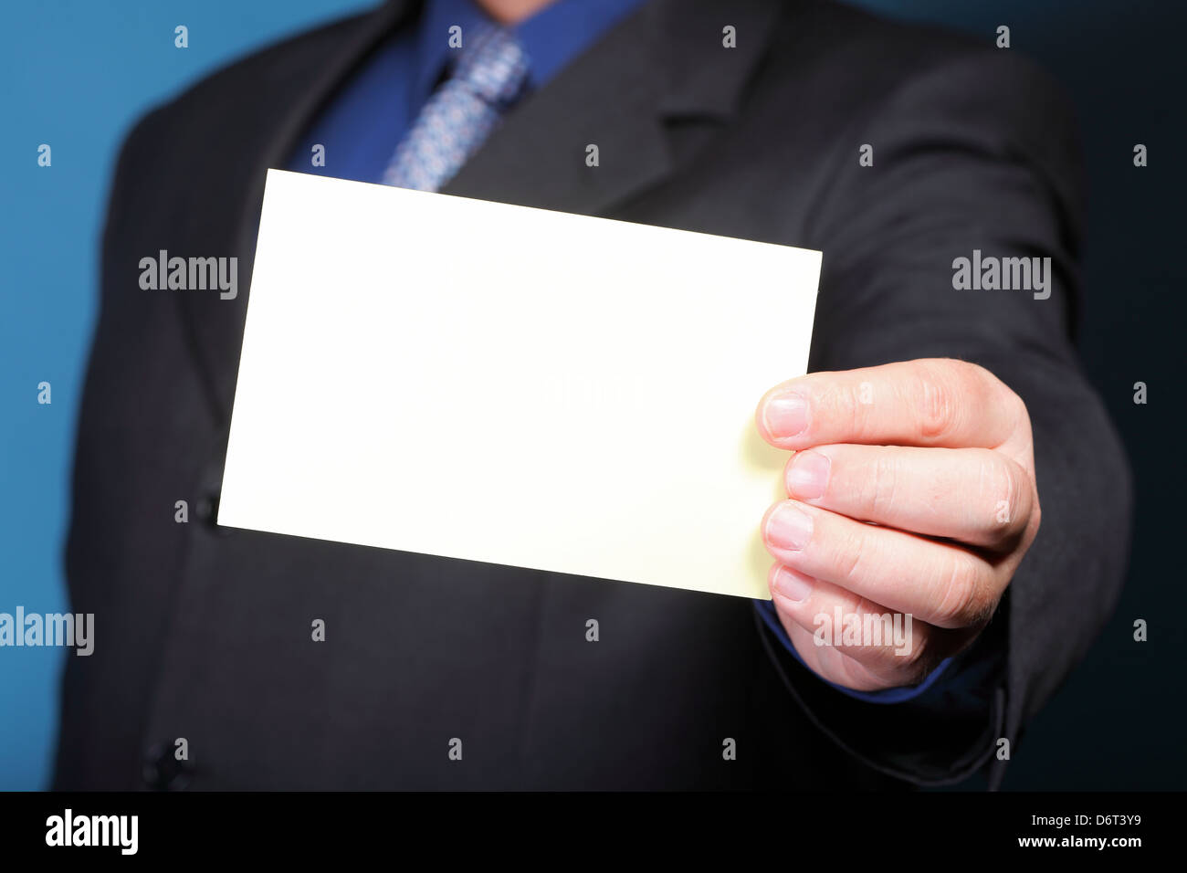Closeup of blank business note card or signboard in man's hand blue ...