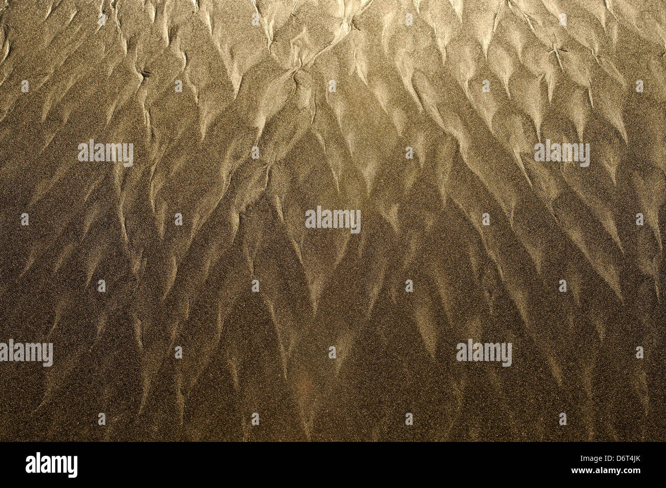 Natural patterns formed on sand by receding water from waves rushing ...