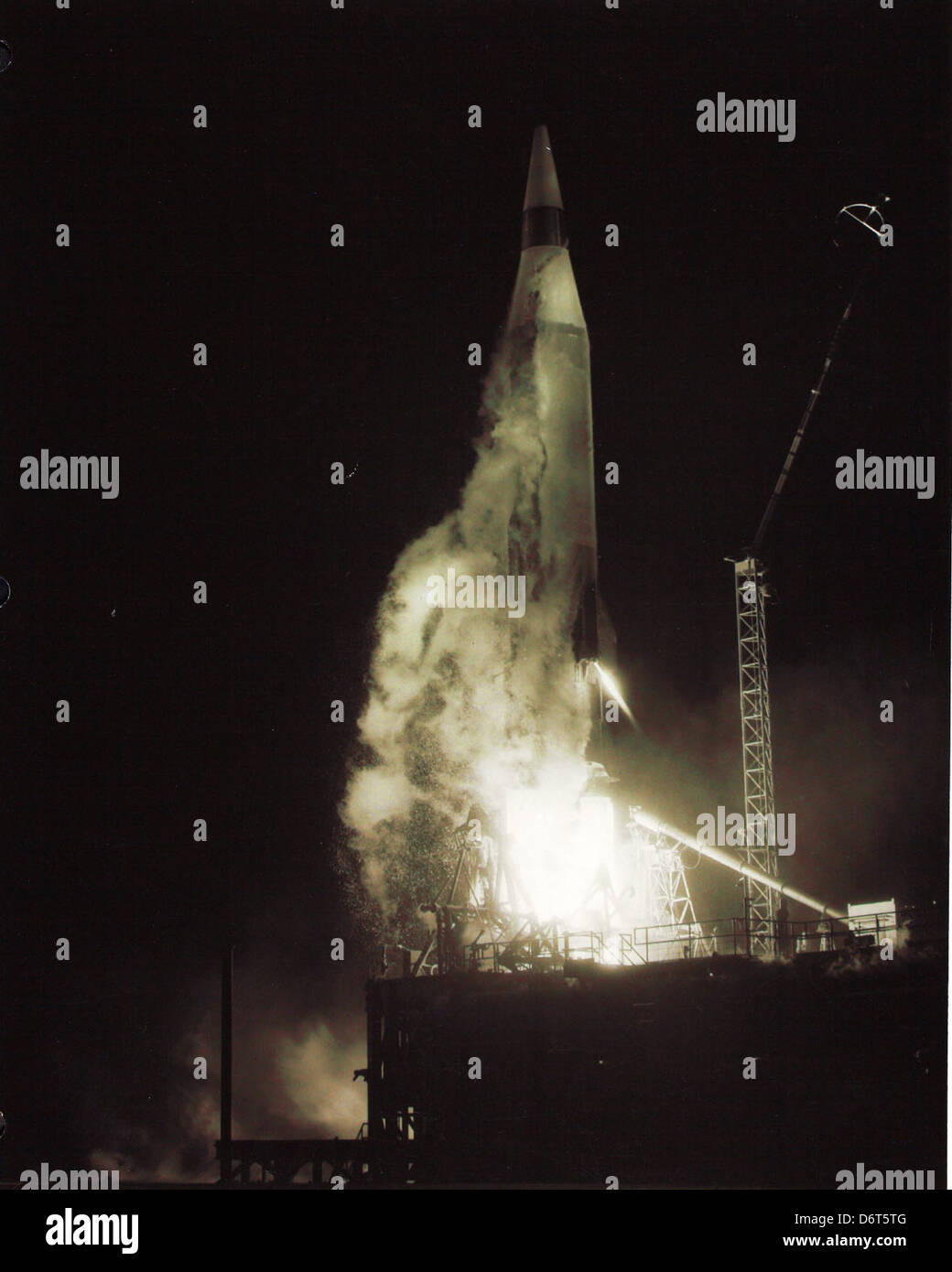 A photograph of the Atlas 76D missile being prepared for launch at ...