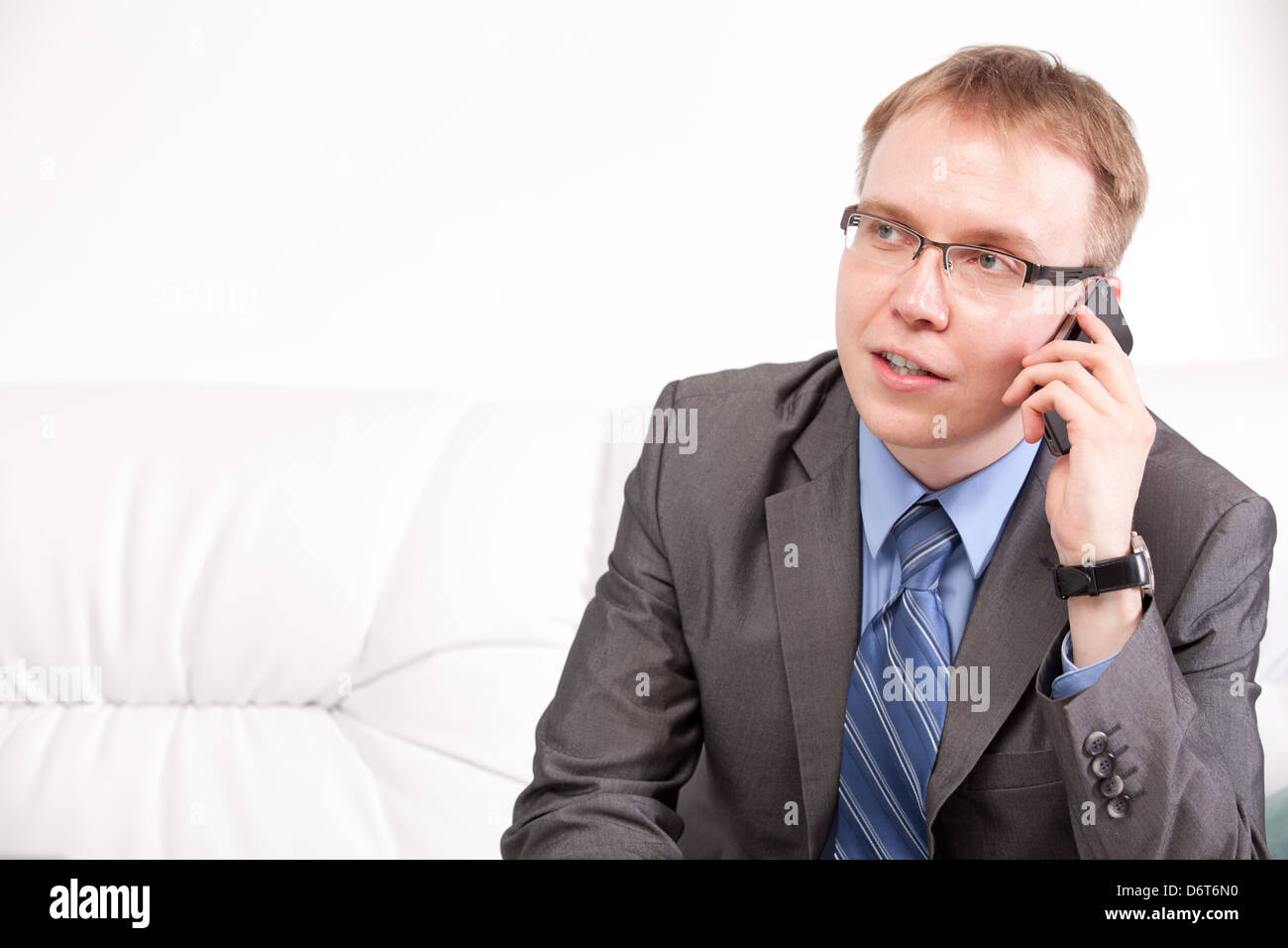 Man sitting on sofa Stock Photo - Alamy