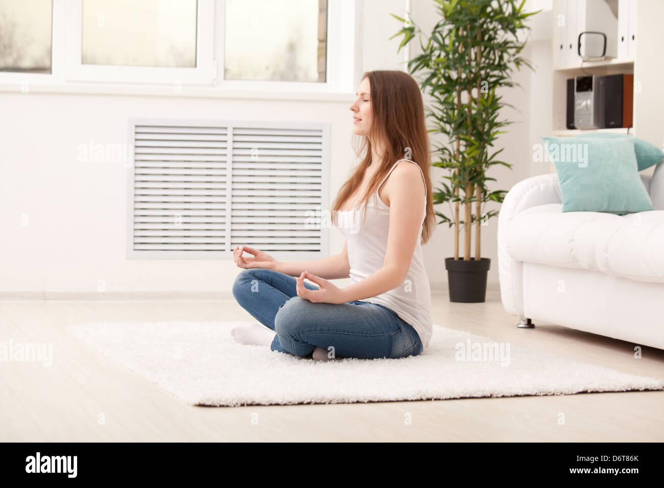 Woman sitting on floor Stock Photo - Alamy