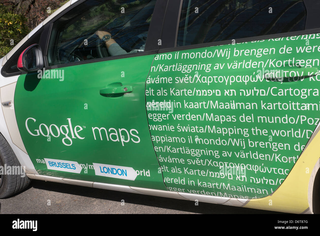 Side view of green and white car with Google maps printed on the door ...