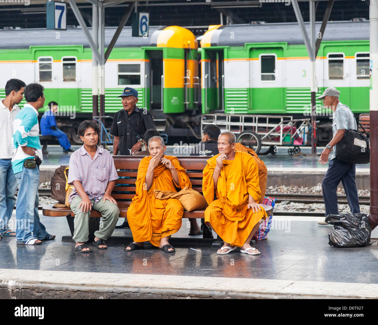 Monks in traditional saffron robes at Bangkok railway station, Thailand ...