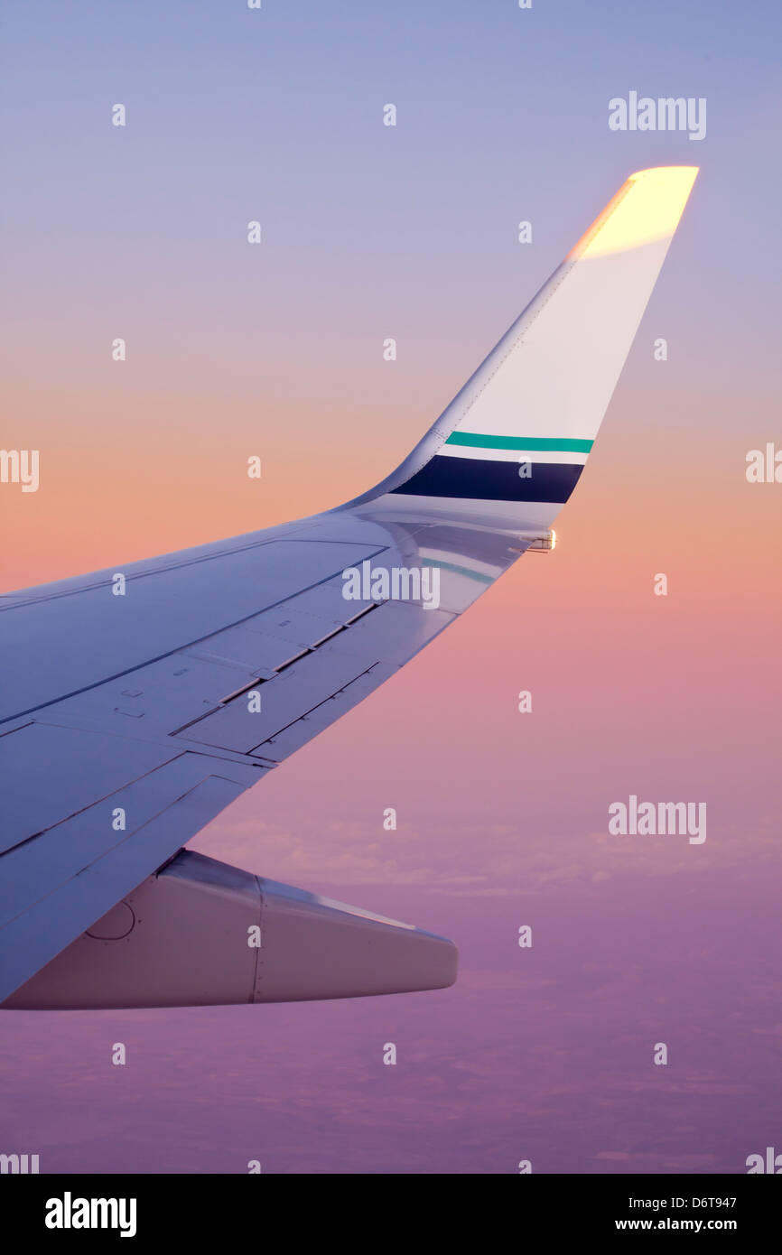 Passenger Jet wing at Sunset Stock Photo - Alamy