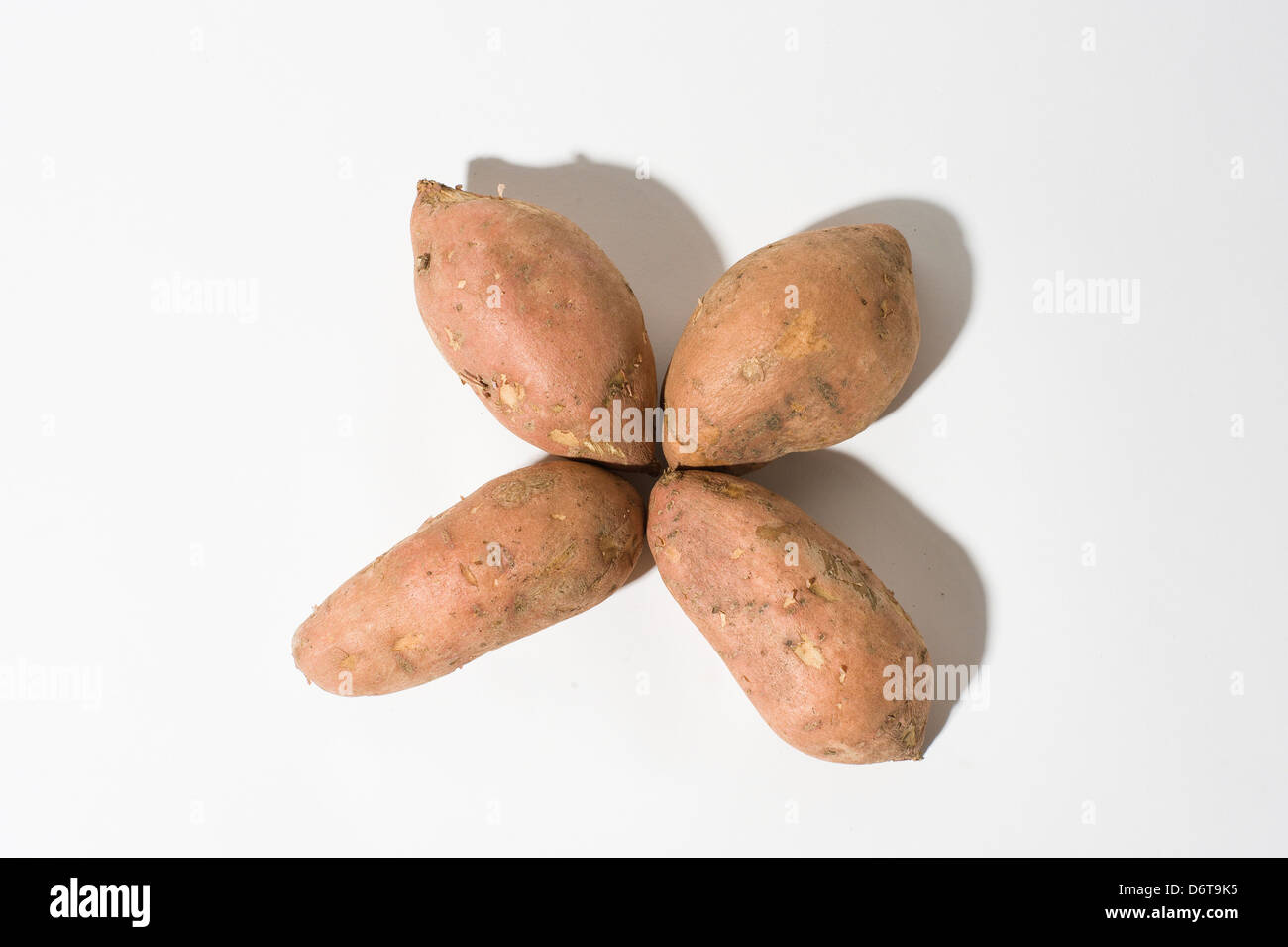 Organic Sweet Potato Yams in clover shape on white background Stock ...