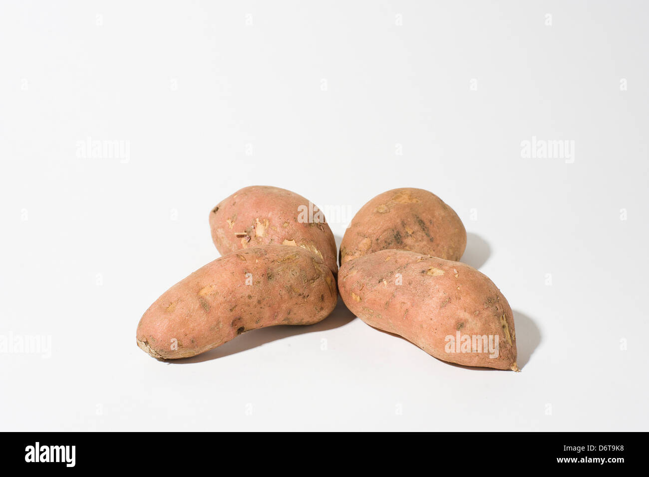 Organic Sweet Potato Yams in clover shape on white background Stock ...
