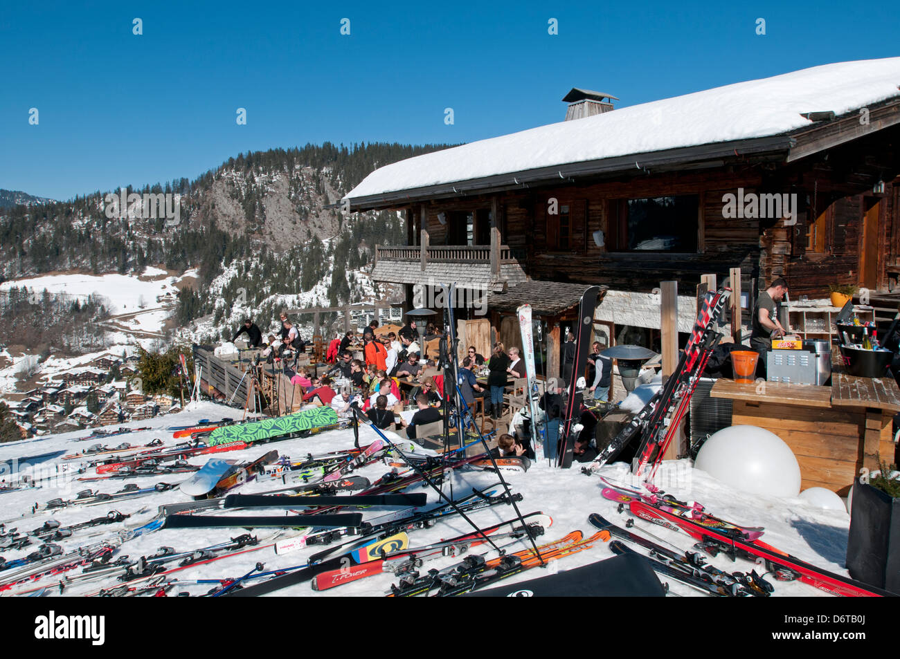 Mountainside restaurant with piles of skis outside on the snow in La ...
