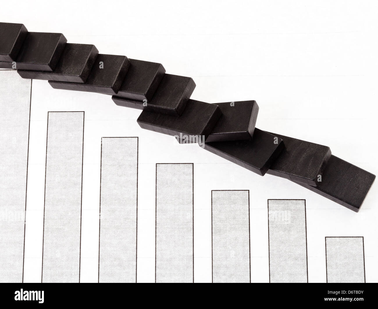 business concept - fallen domino and sales fall diagram Stock Photo - Alamy