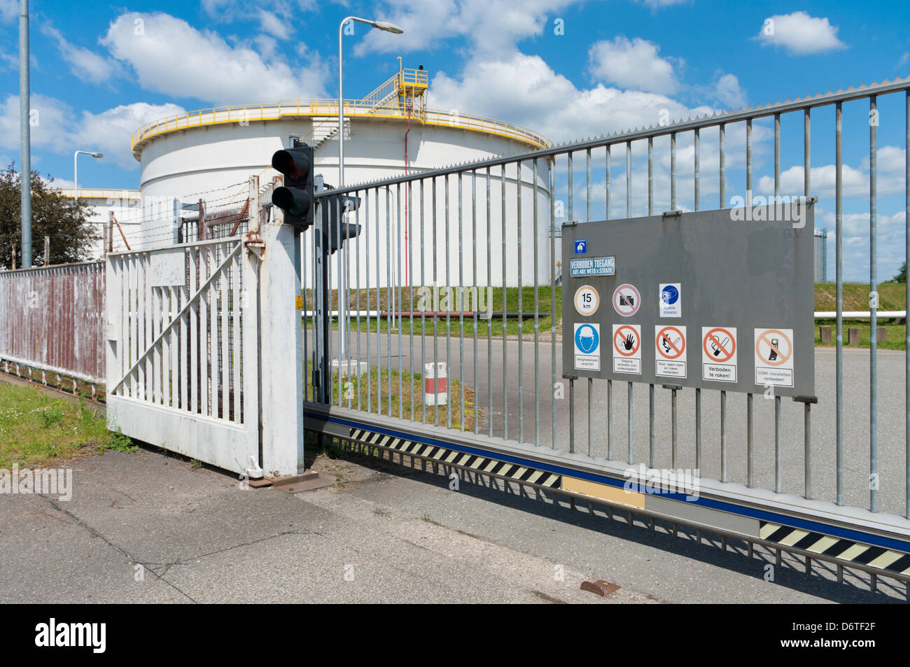 metal gate in front of an area with oil storage tanks in Amsterdam ...