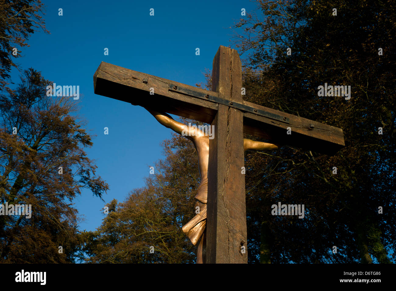 Crucifix outside French village, trees, blue sky, Normandy, France ...