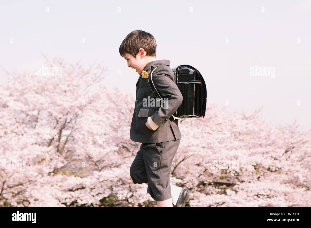 Young boy in school uniform walking Stock Photo - Alamy