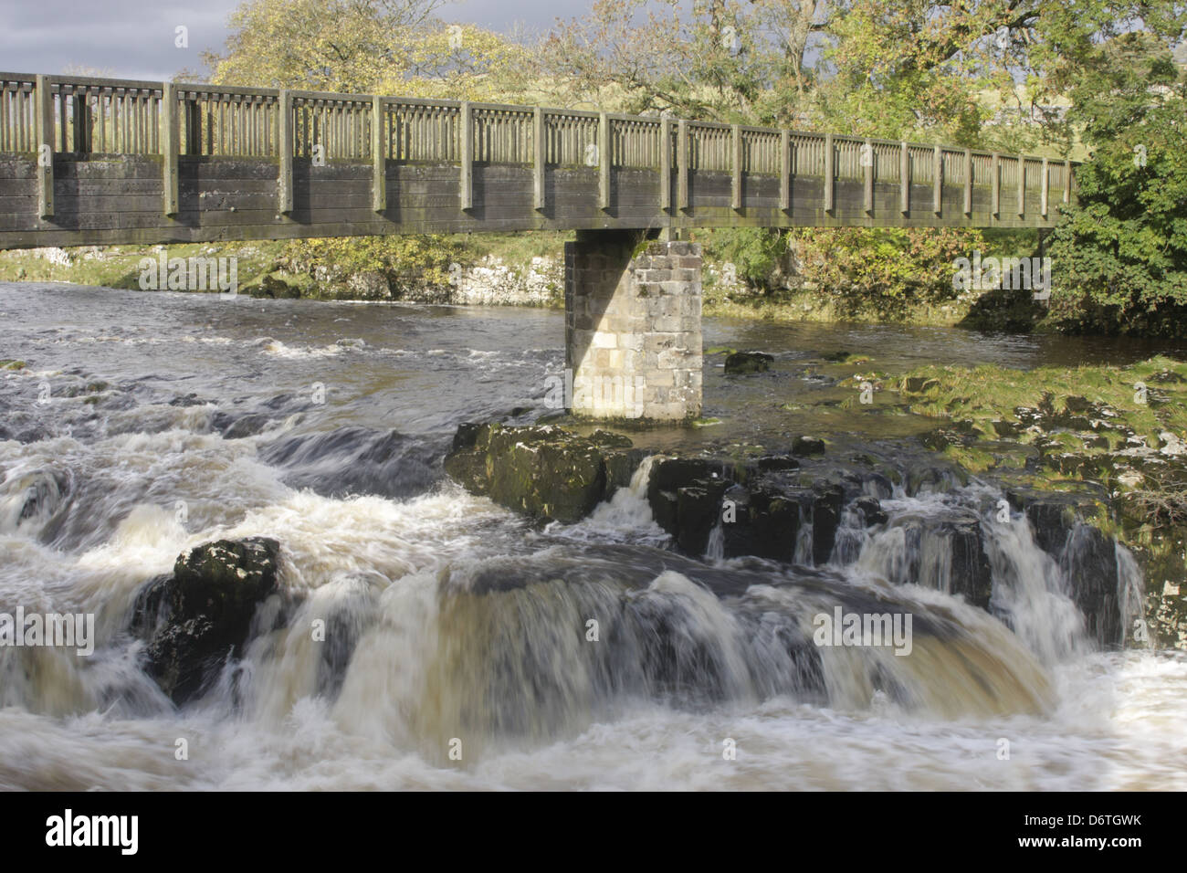Bridge cascades over limestone rocks Linton Falls River Wharfe ...