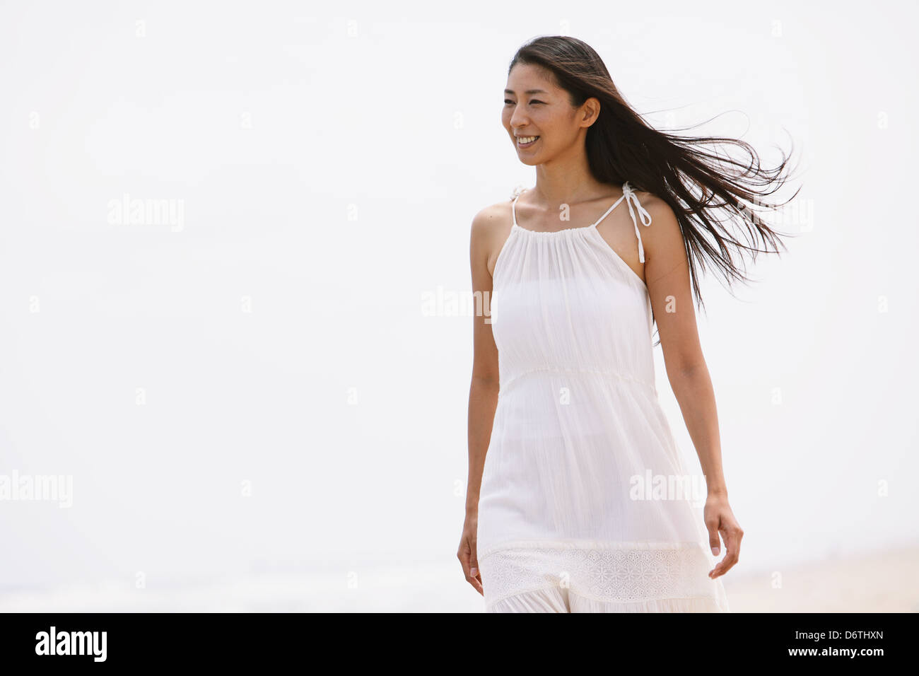 Woman in a white dress smiling away Stock Photo - Alamy