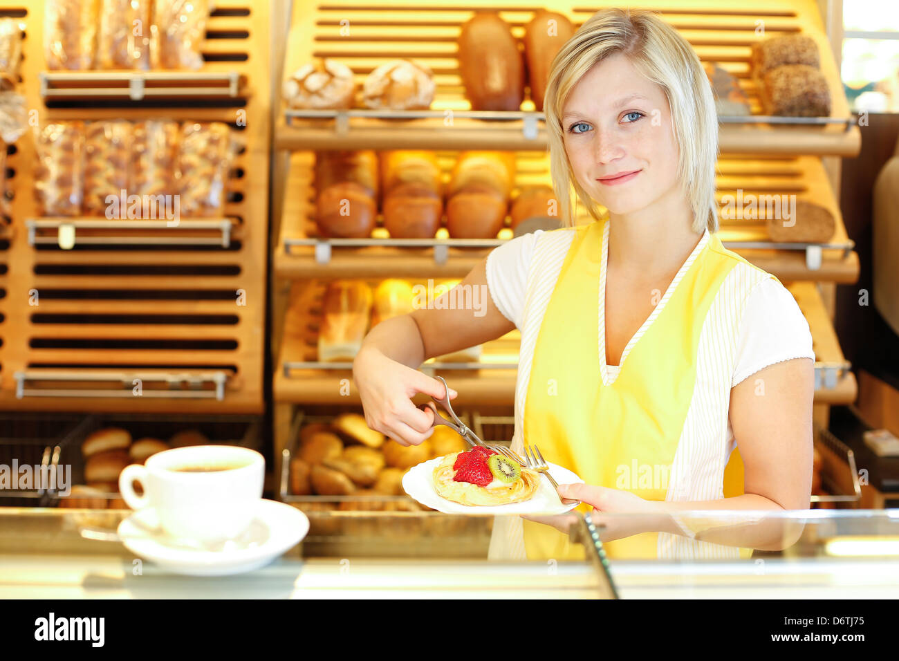 Bakery shopkeeper preparing coffee and cake for customer Stock Photo ...