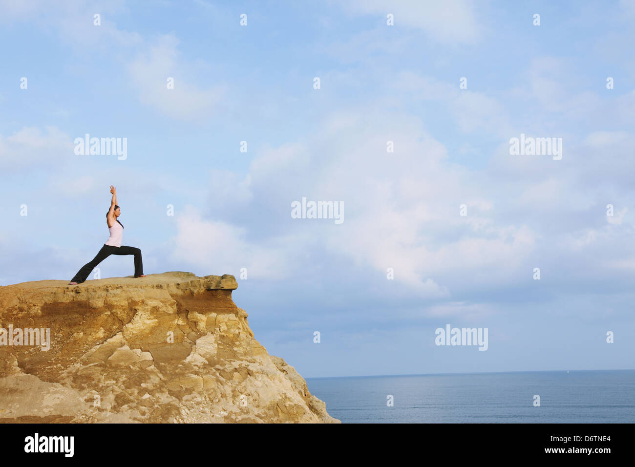 Woman practicing Yoga on a cliff Stock Photo - Alamy