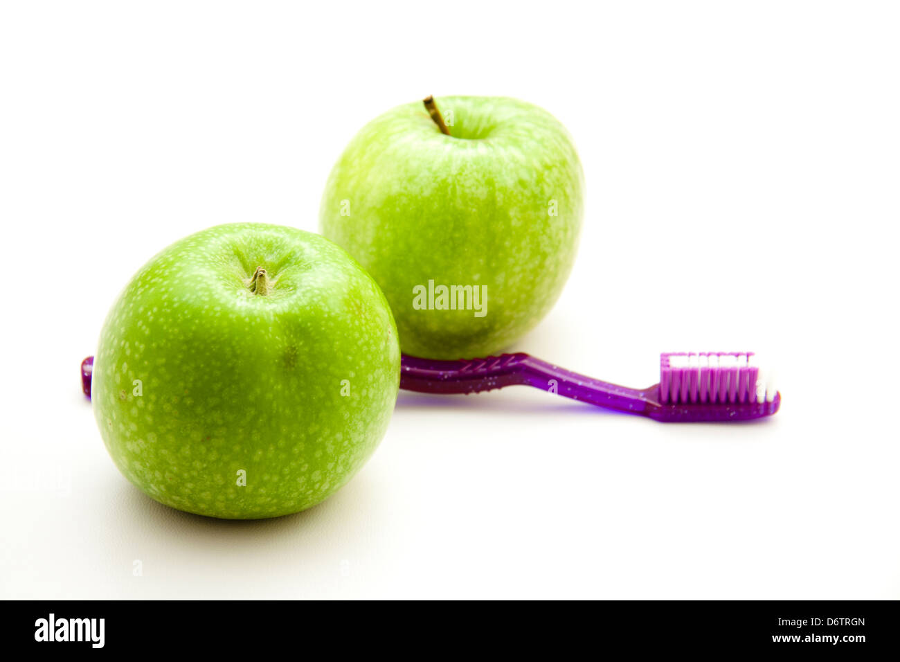 Green apple with toothbrush Stock Photo - Alamy