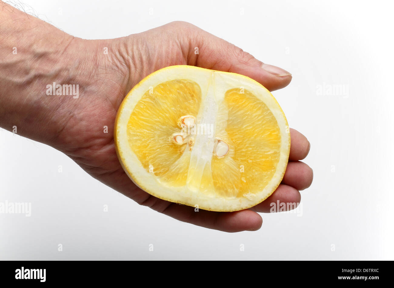 A grapefruit held in a man's hand Stock Photo - Alamy