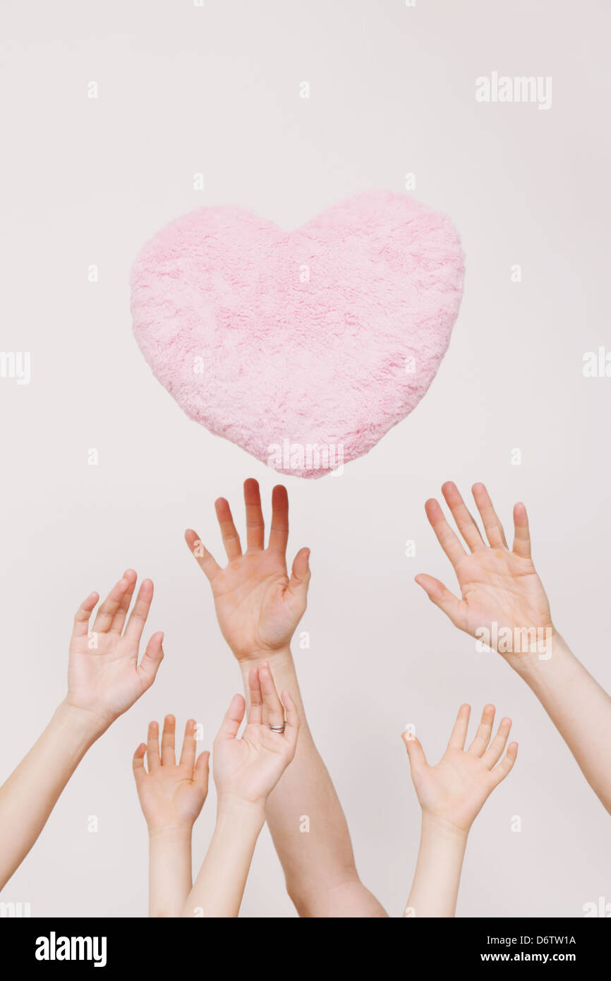 Hands reaching out for heart Stock Photo - Alamy