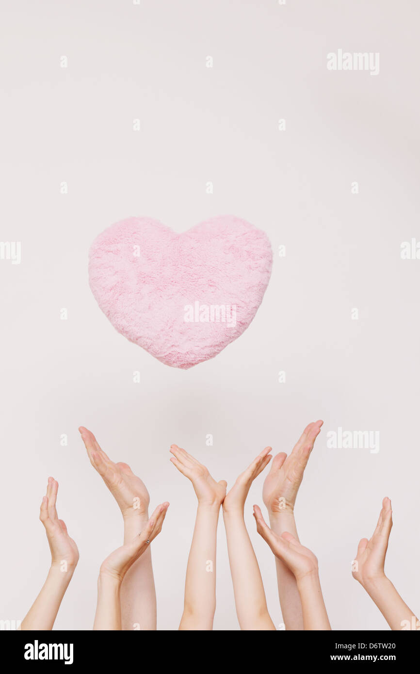 Hands reaching out for heart Stock Photo - Alamy