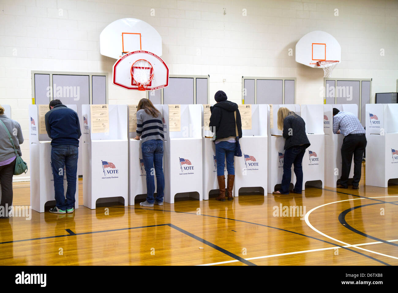 People vote in cardboard voting booths at a polling station in Boise ...