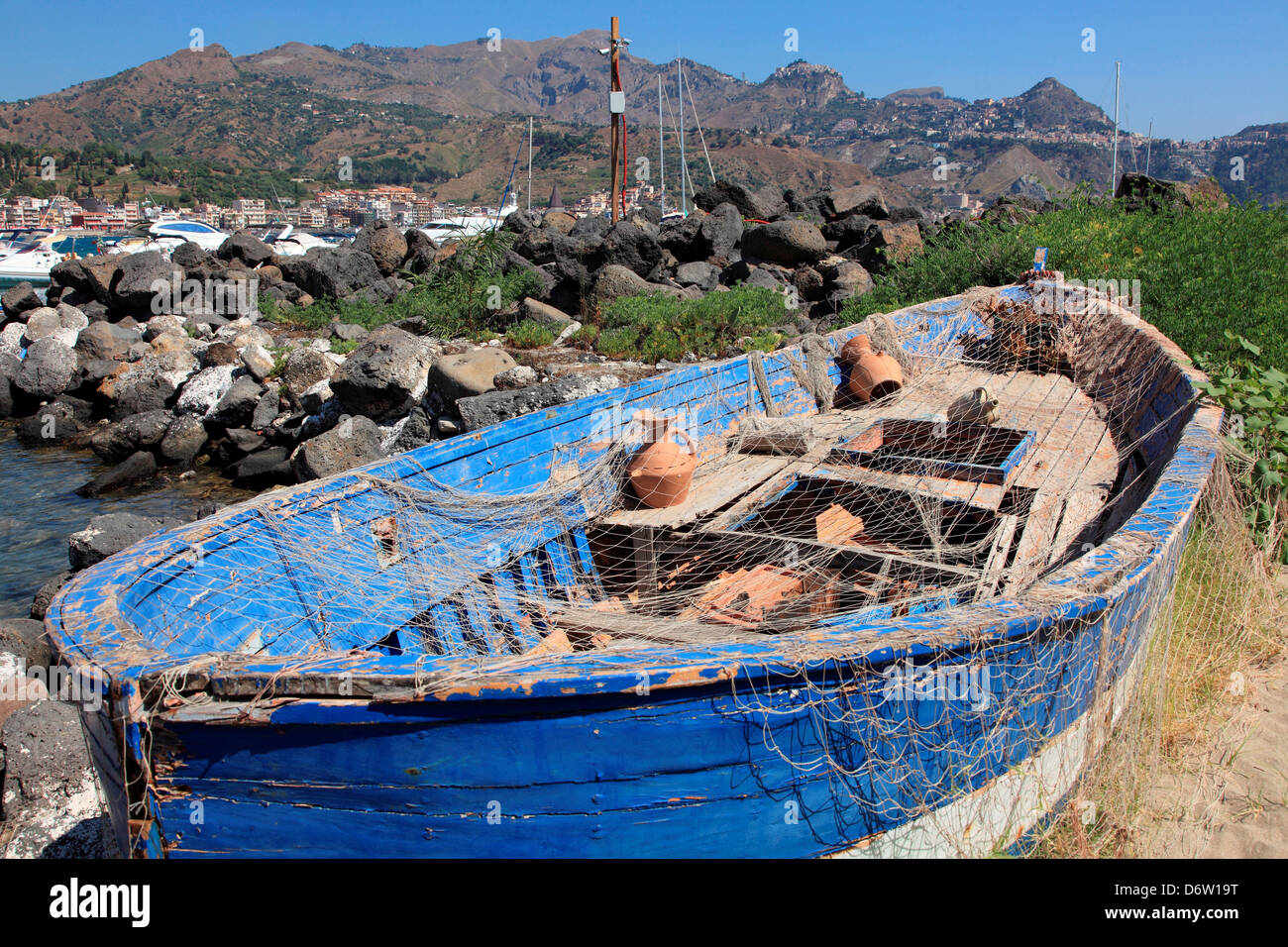 Italy, Sicily, Taormina, Old fishing boats with terracotta artifacts ...