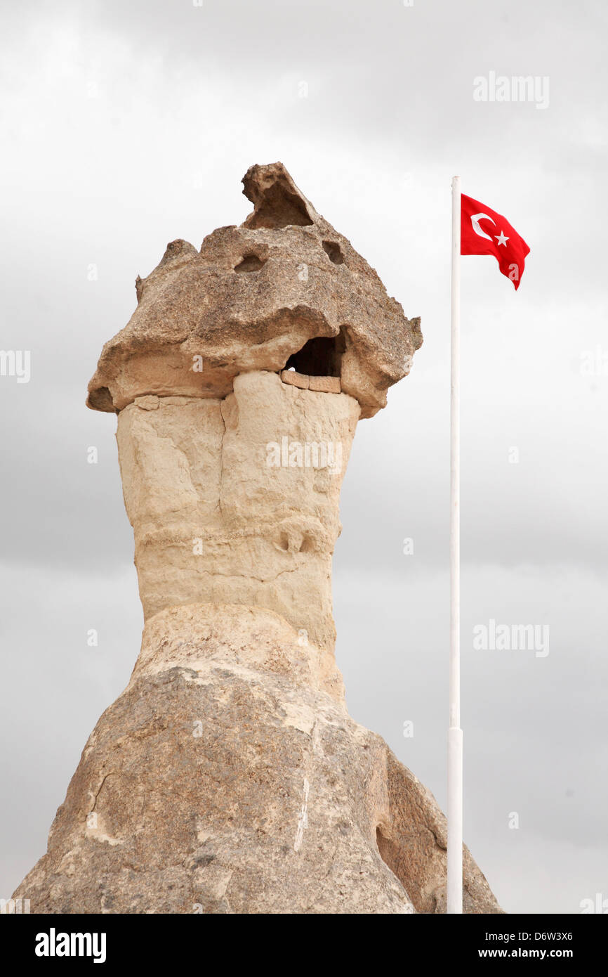 Turkish flag next to a volcanic tufa, Uchisar, Cappadocia, Central ...