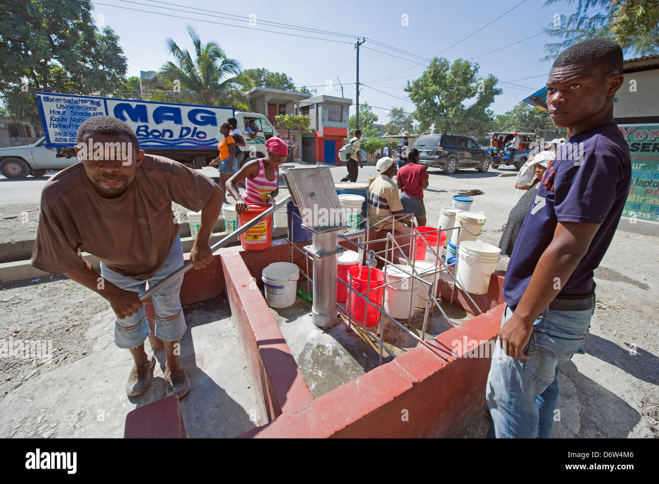man pumping water, Port au Prince, Haiti, Caribbean Stock Photo - Alamy