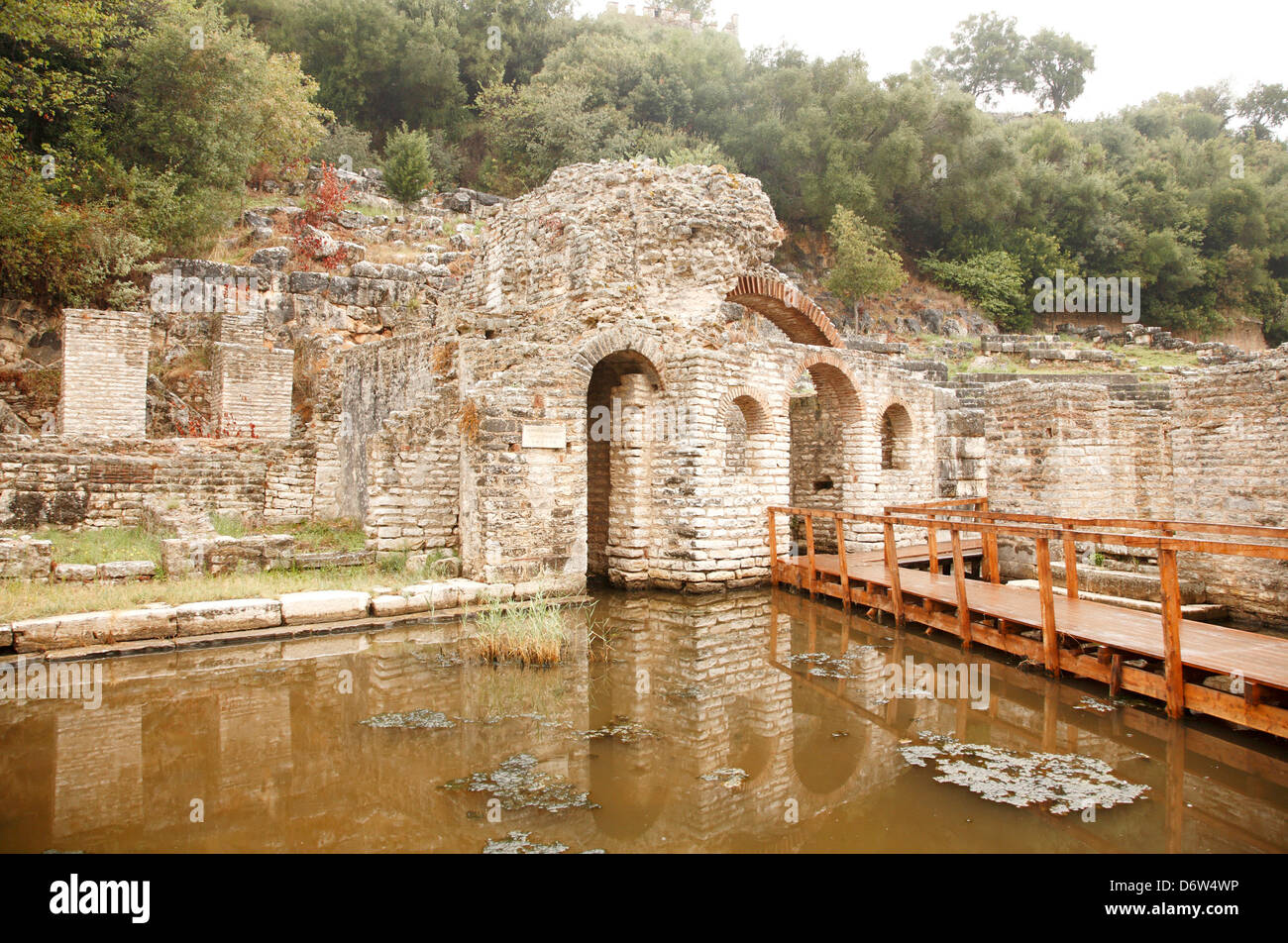Remains of Asclepius Temple with an amphitheater in the background ...