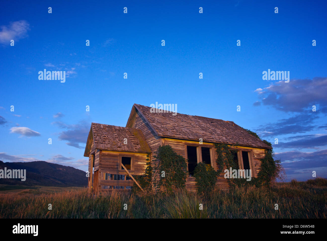 An old log cabin slowly falls apart on abandoned farmland Stock Photo ...