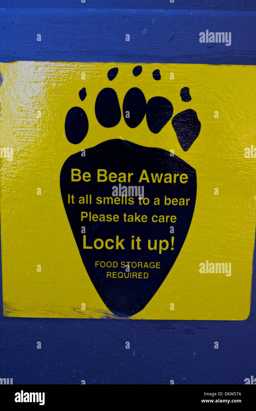 A national park sign warns of the danger bears pose and offers rules on ...