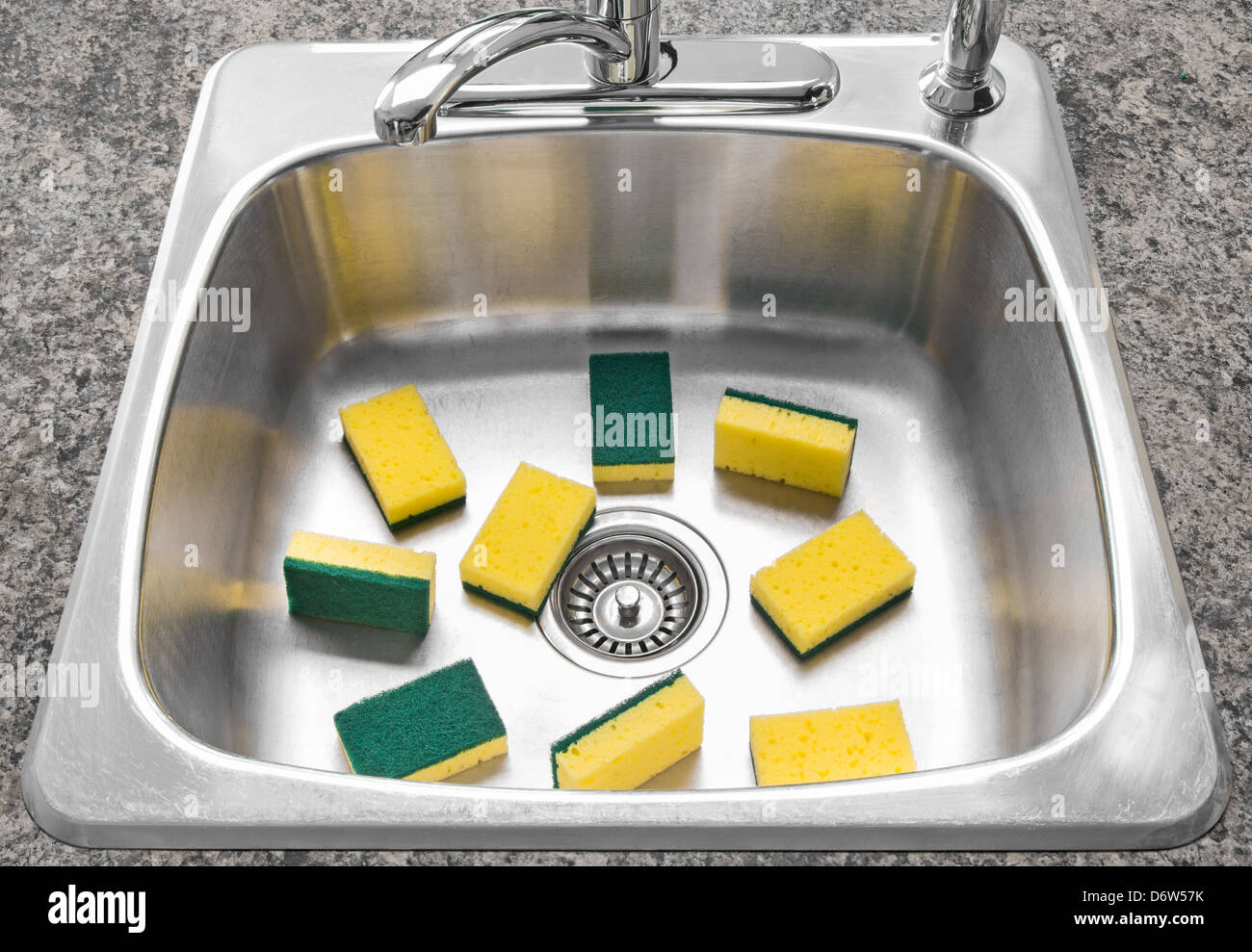Lots of yellow and green sponges in a clean shiny kitchen sink Stock ...