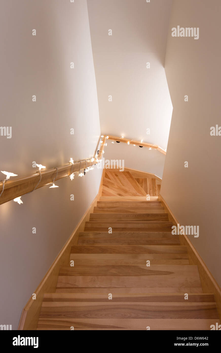Wooden staircase decorated with cozy lights. Home interior Stock Photo ...