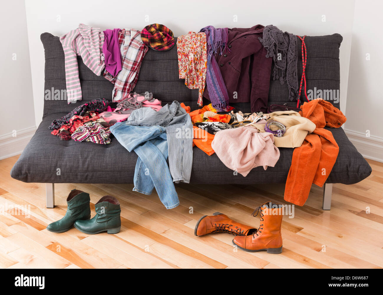 What to wear? Messy colorful clothing on a sofa Stock Photo - Alamy