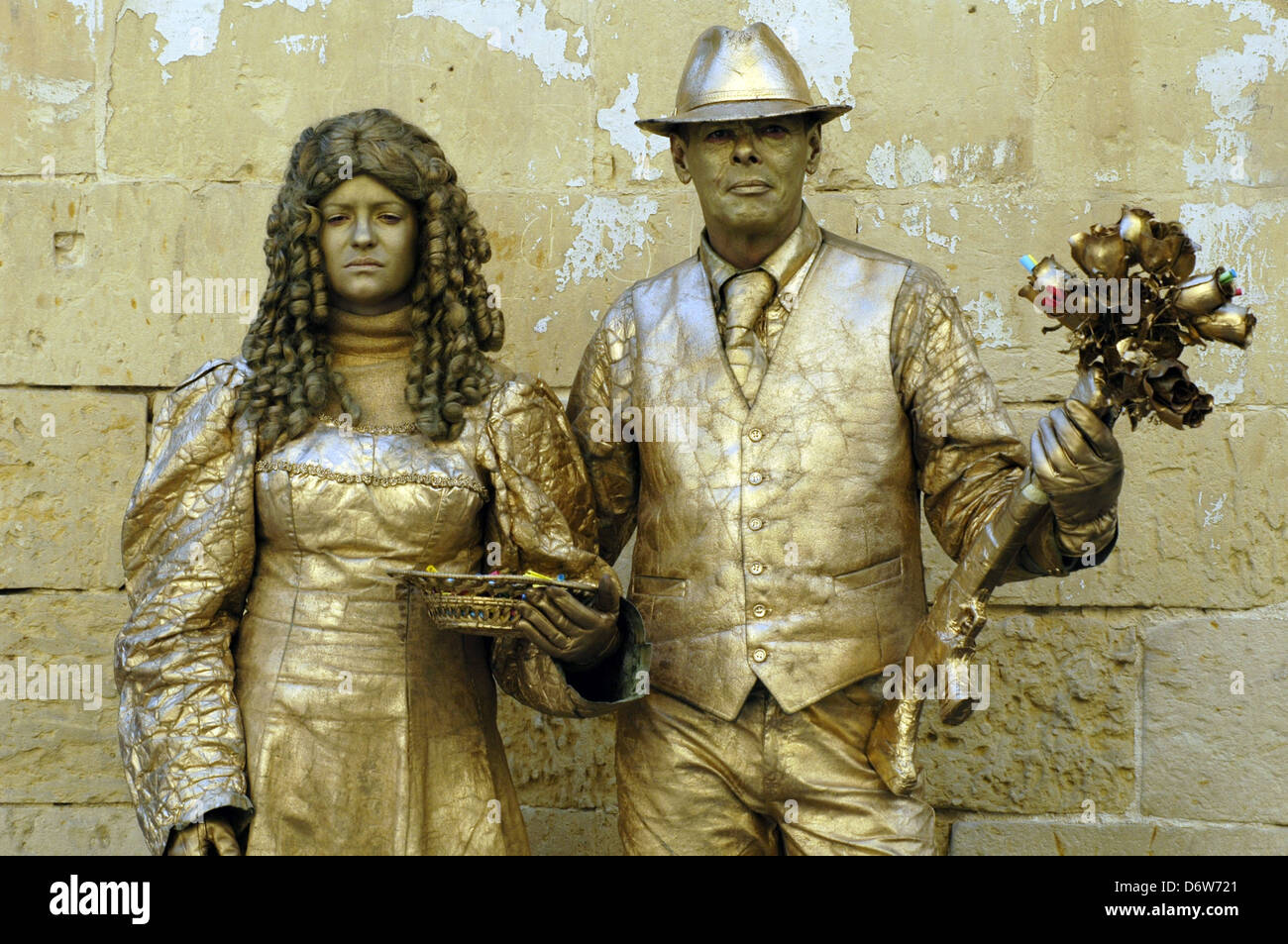 Mime artists painted in gold depict frozen statues in Valleta Malta ...