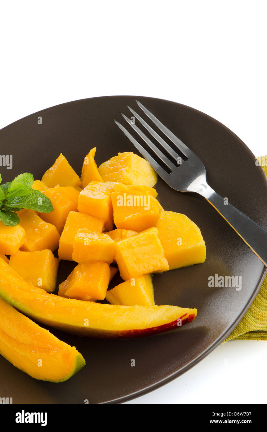 Mango fruit on brown plate on white background Stock Photo - Alamy