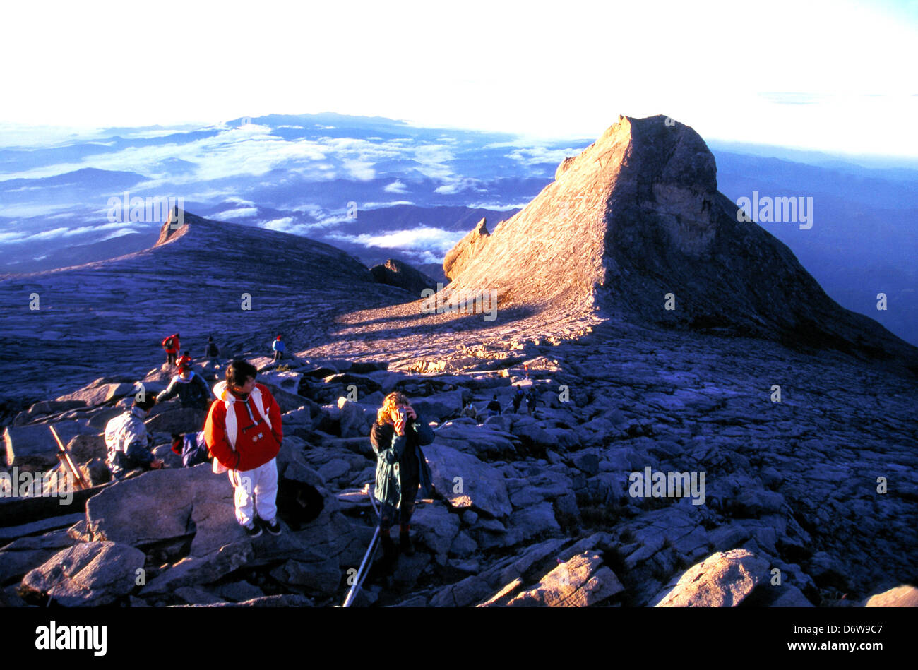 Malaysia, Sabah, Mount Kinabalu, Hikers looking at view from peak of ...