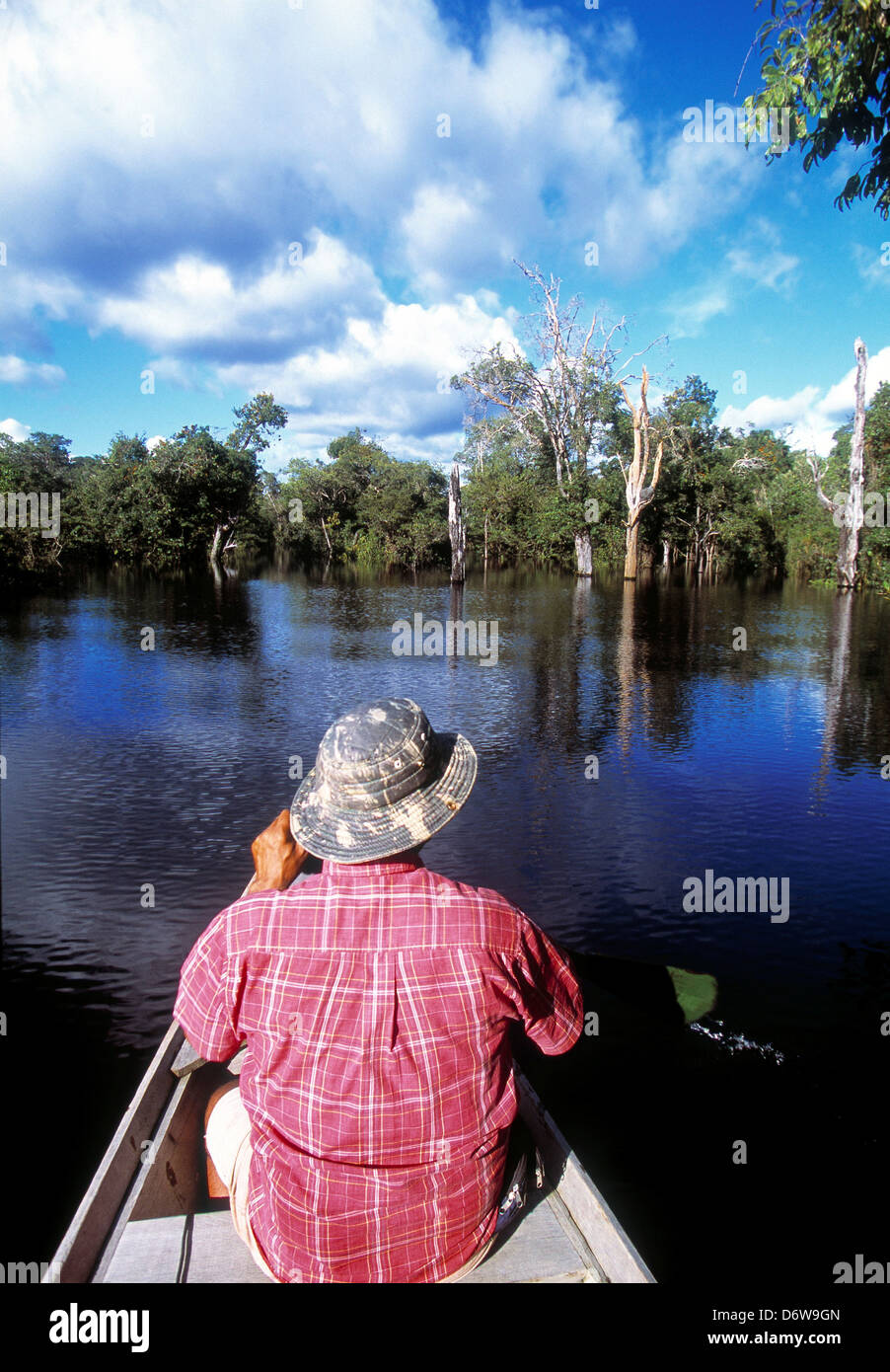 Brazil, Amazon River, Local Guide sitting in small rowing boat Stock ...