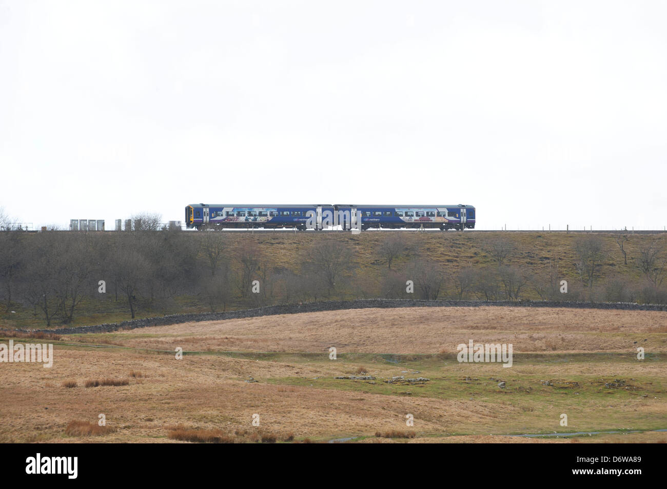 Northern rail train in West Yorkshire livery on embankment approaching ...