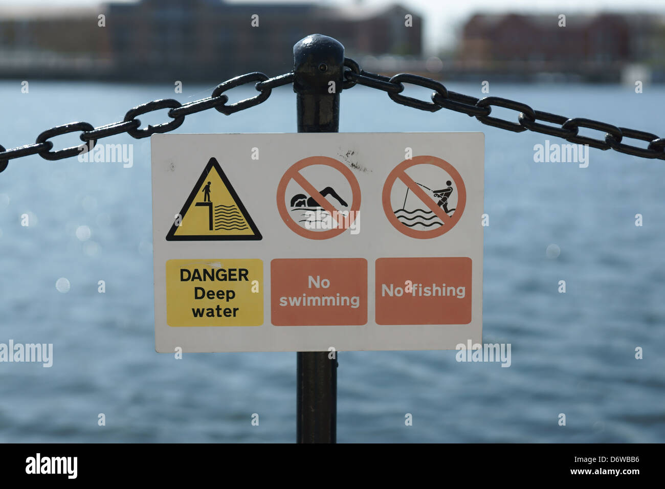 sun glooming water surface danger sign metal pole Stock Photo - Alamy
