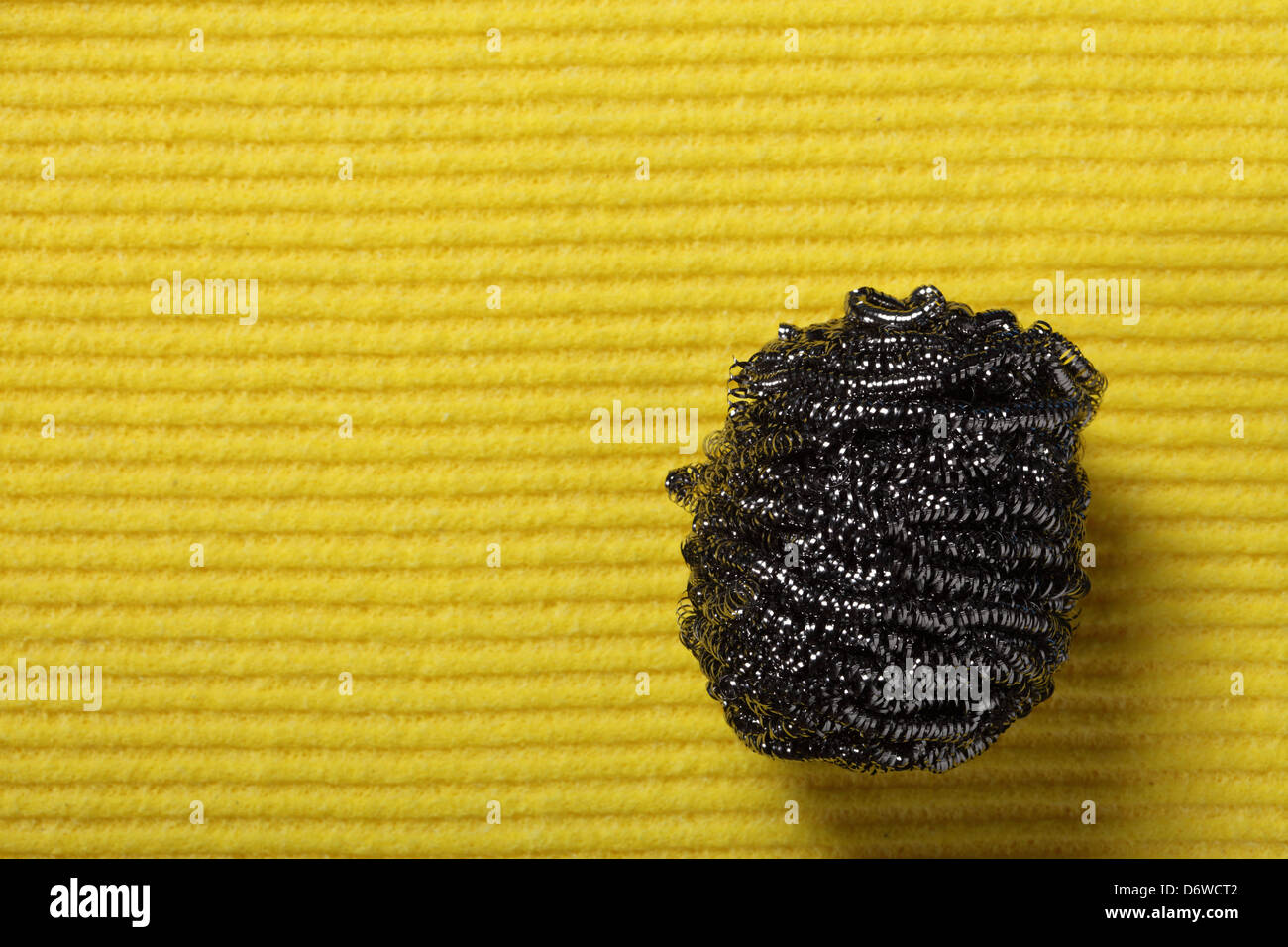 Yellow sponge background and stainless steel pan scourer Stock Photo ...