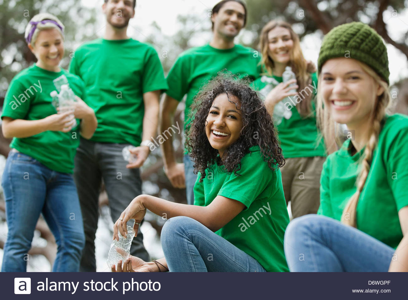 Beautiful young woman holding recycling bin isolated on white ...