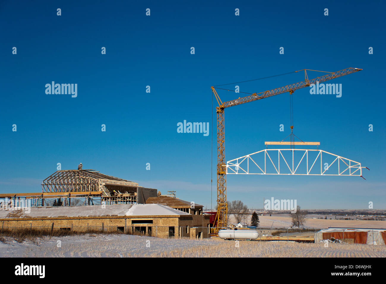 Crane lifting wooden frame Stock Photo - Alamy