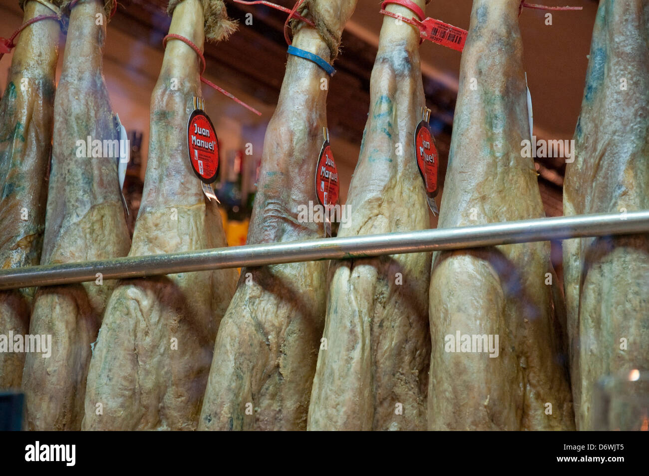 Spain, Madrid, Bacon hanging in window of restaurant Stock Photo - Alamy