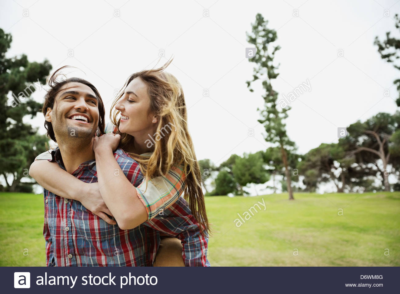 Young man giving girlfriend piggyback ride hi-res stock photography and ...