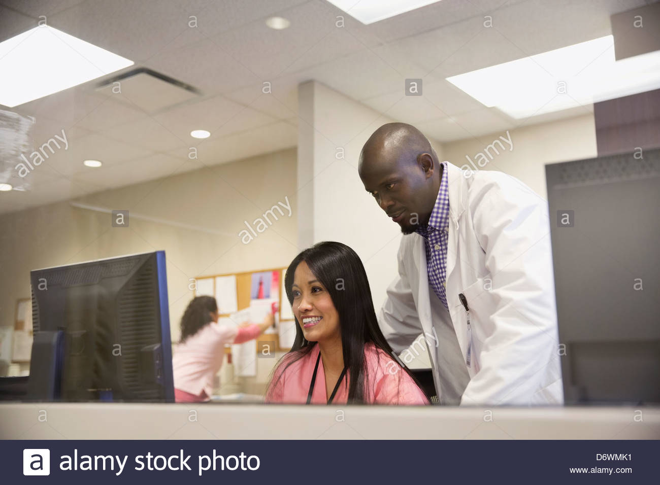 Doctor nurse looking computer monitor hi-res stock photography and ...