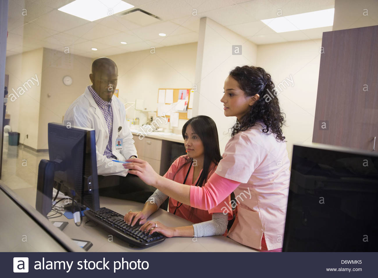 Doctor nurse looking computer monitor hi-res stock photography and ...