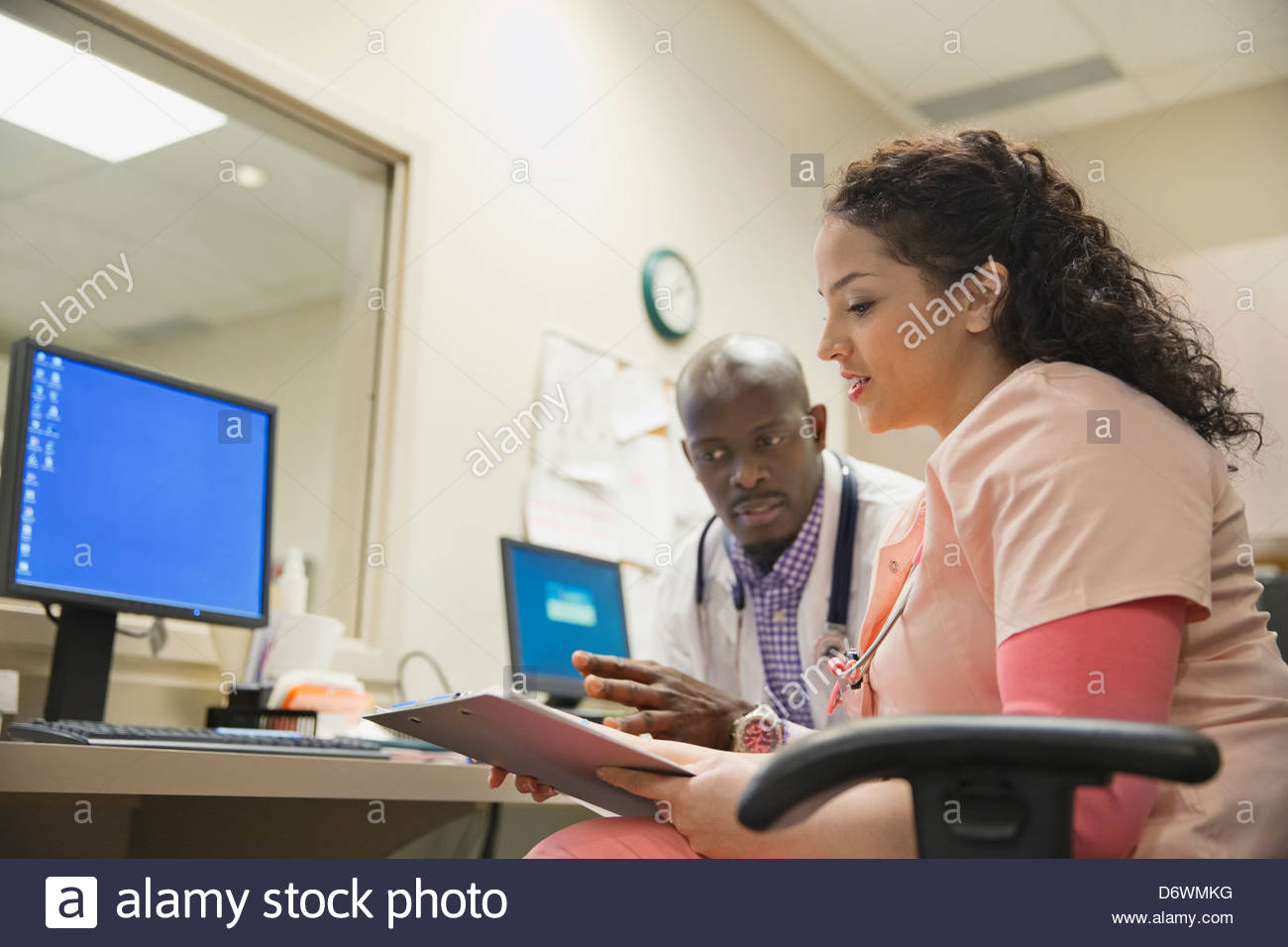 Medical professionals medical records together in clinic Stock Photo ...
